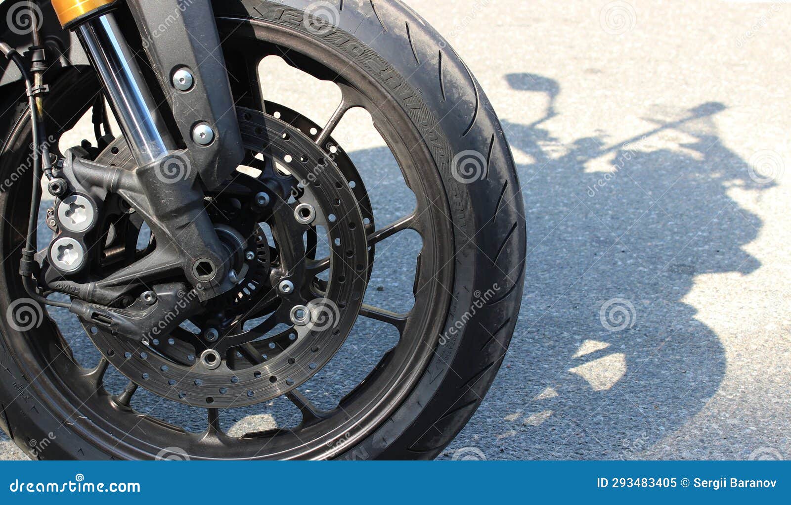 Wheel of Motorcycle Standing on the Roadside and Its Shadow on the ...