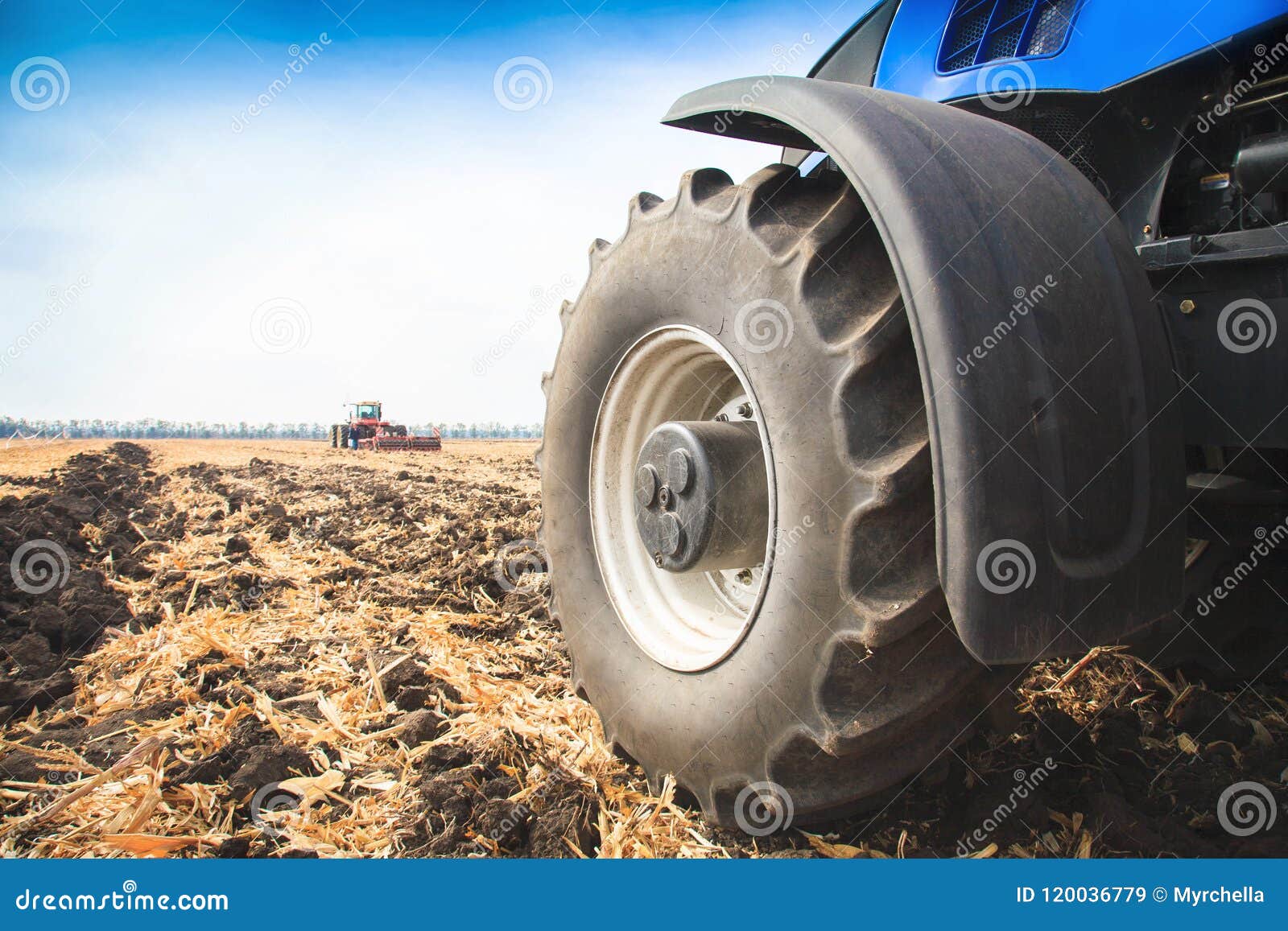 A Wheel from a Tractor Working in the Field Close Up. the Concept of ...