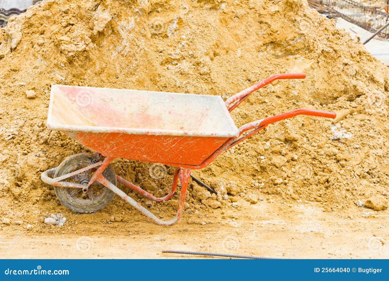 Wheelbarrow on the Background of the Mound of Sand Stock Photo - Image ...