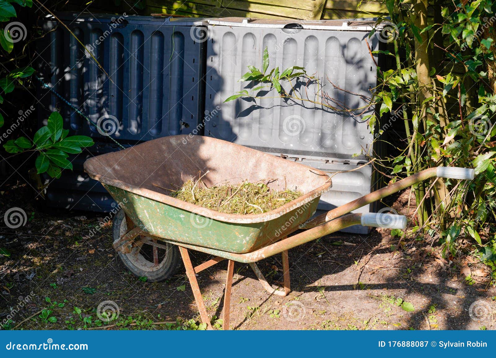 Wheelbarrow and Compost Bin in the Home Garden in Sunny Day Stock Image ...