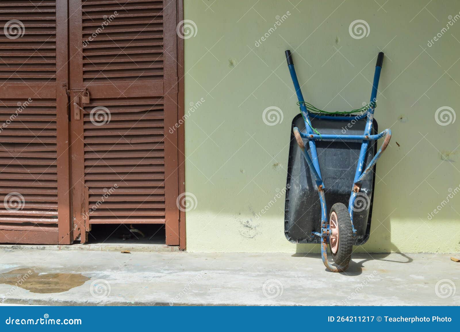 Wheelbarrow or Construction Cart Laid on Wall Stock Image - Image of ...