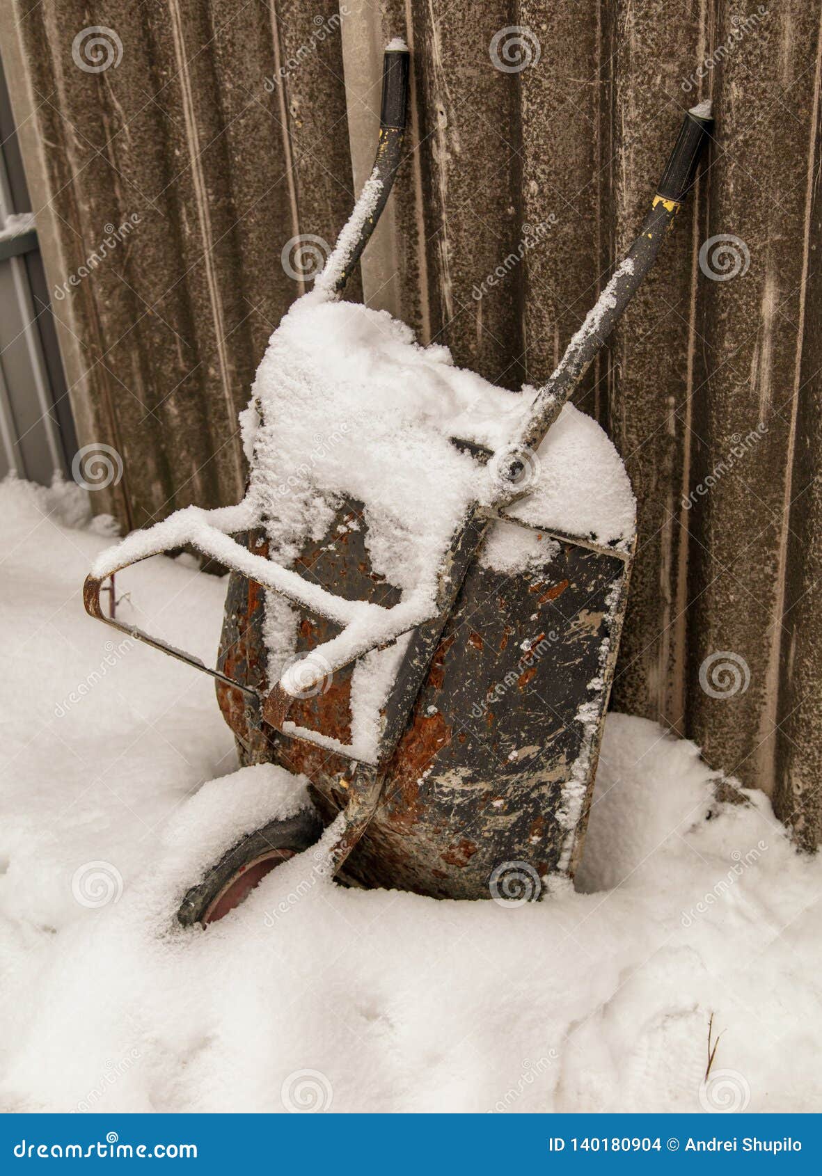 Wheelbarrow at a Construction Site in the Snow in Winter Stock Photo ...