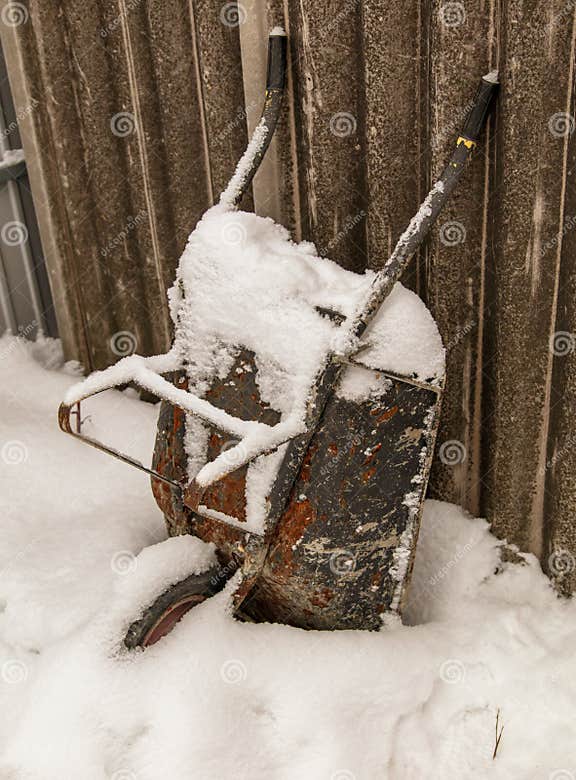 Wheelbarrow at a Construction Site in the Snow in Winter Stock Photo ...
