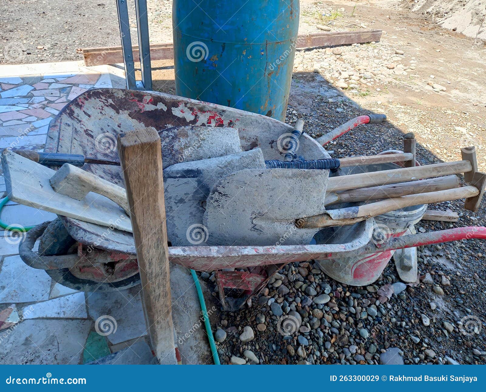 A Wheelbarrow Full of Dirty Equipment on a Construction Site Stock ...