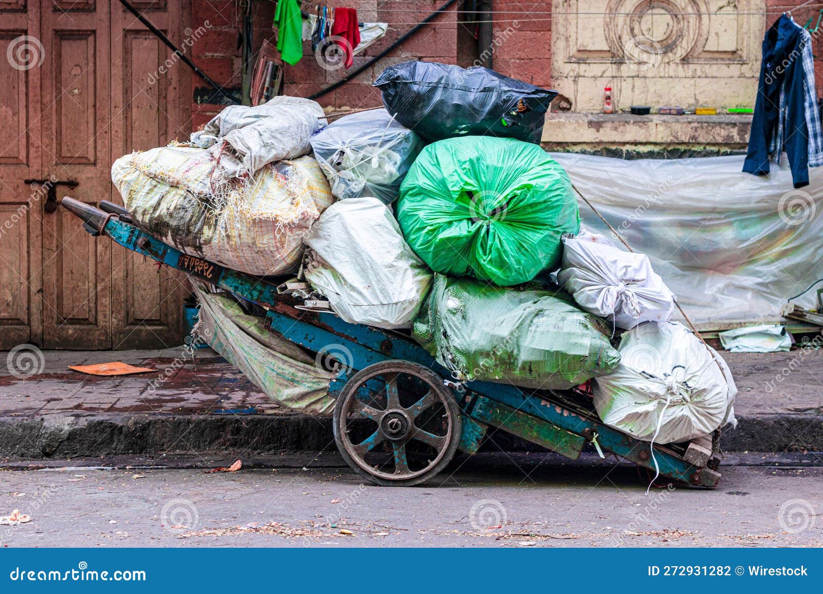 Wheelbarrow Full of Garbage on the Side of a Street. Stock Photo ...