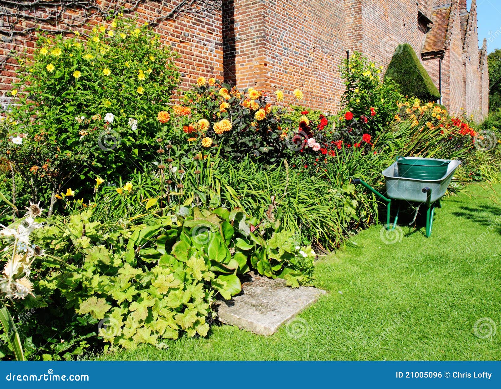 Wheelbarrow Next To a Colorful Flower Border Stock Photo - Image of ...