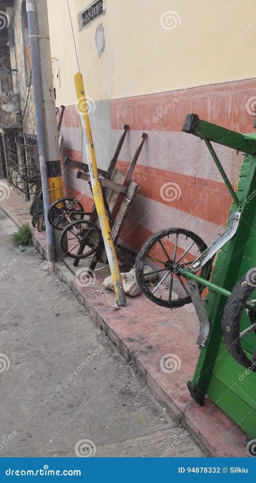 Wheelbarrows on the street stock photo. Image of walking - 94878332