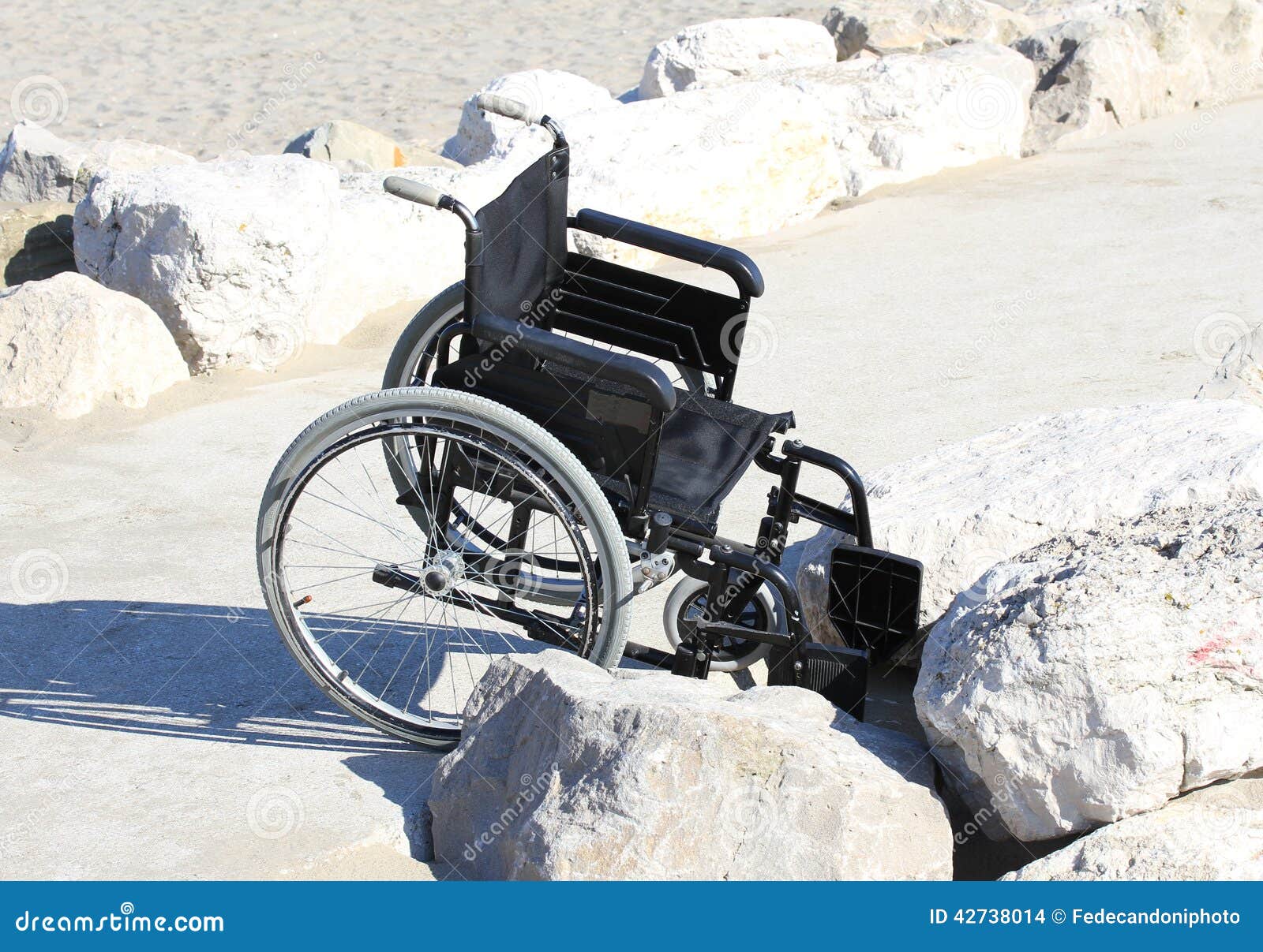 Wheelchair Stuck on the Rocks by the Sea Stock Photo - Image of ...