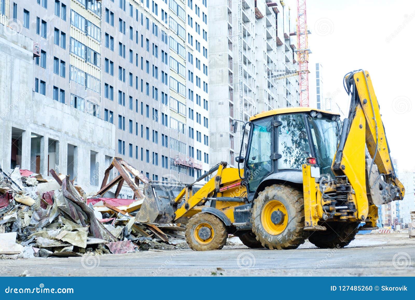 A Wheeled Backhoe Loader Removes Garbage on the Construction Site ...