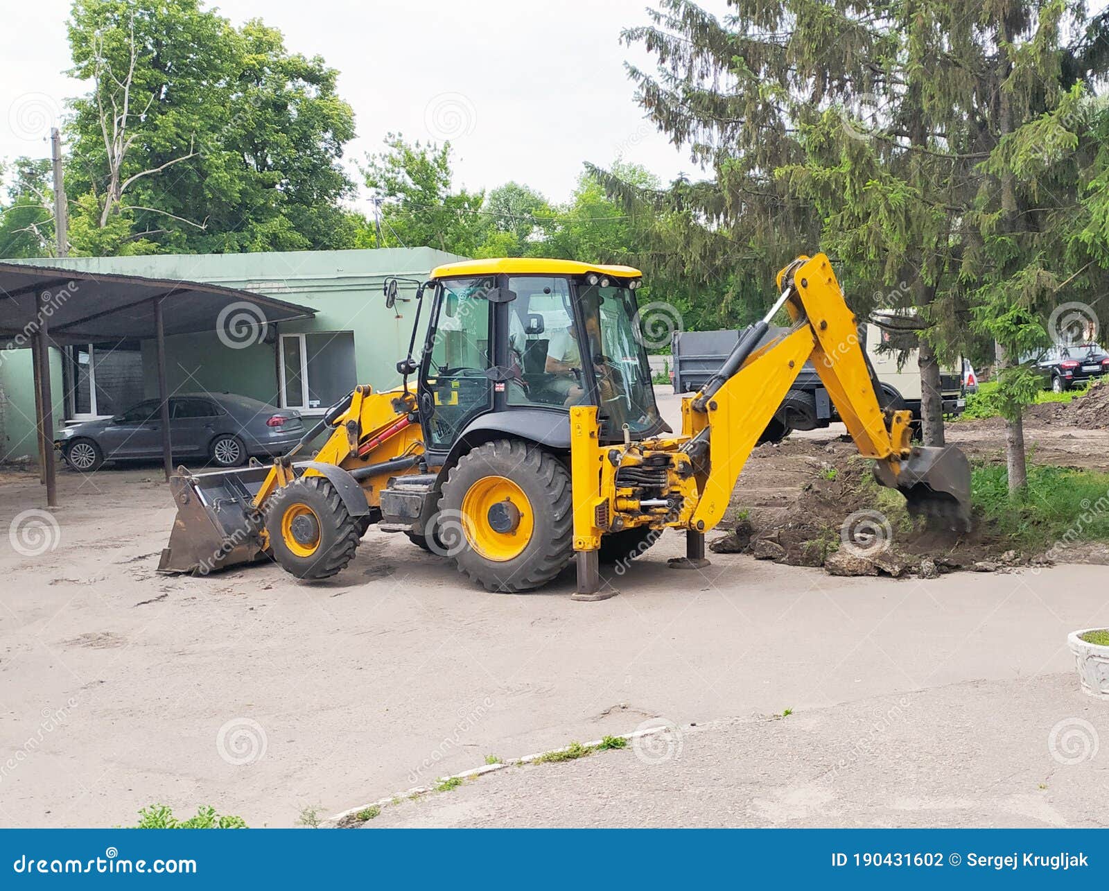 Wheeled Excavator with a Metal Bucket for Digging Trenches Stock Photo ...