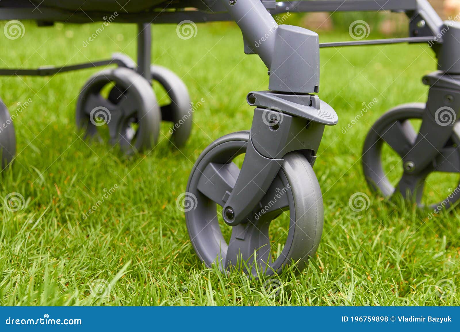 Wheels of a Stroller on the Grass,close Up of Trolley with Adjustable ...