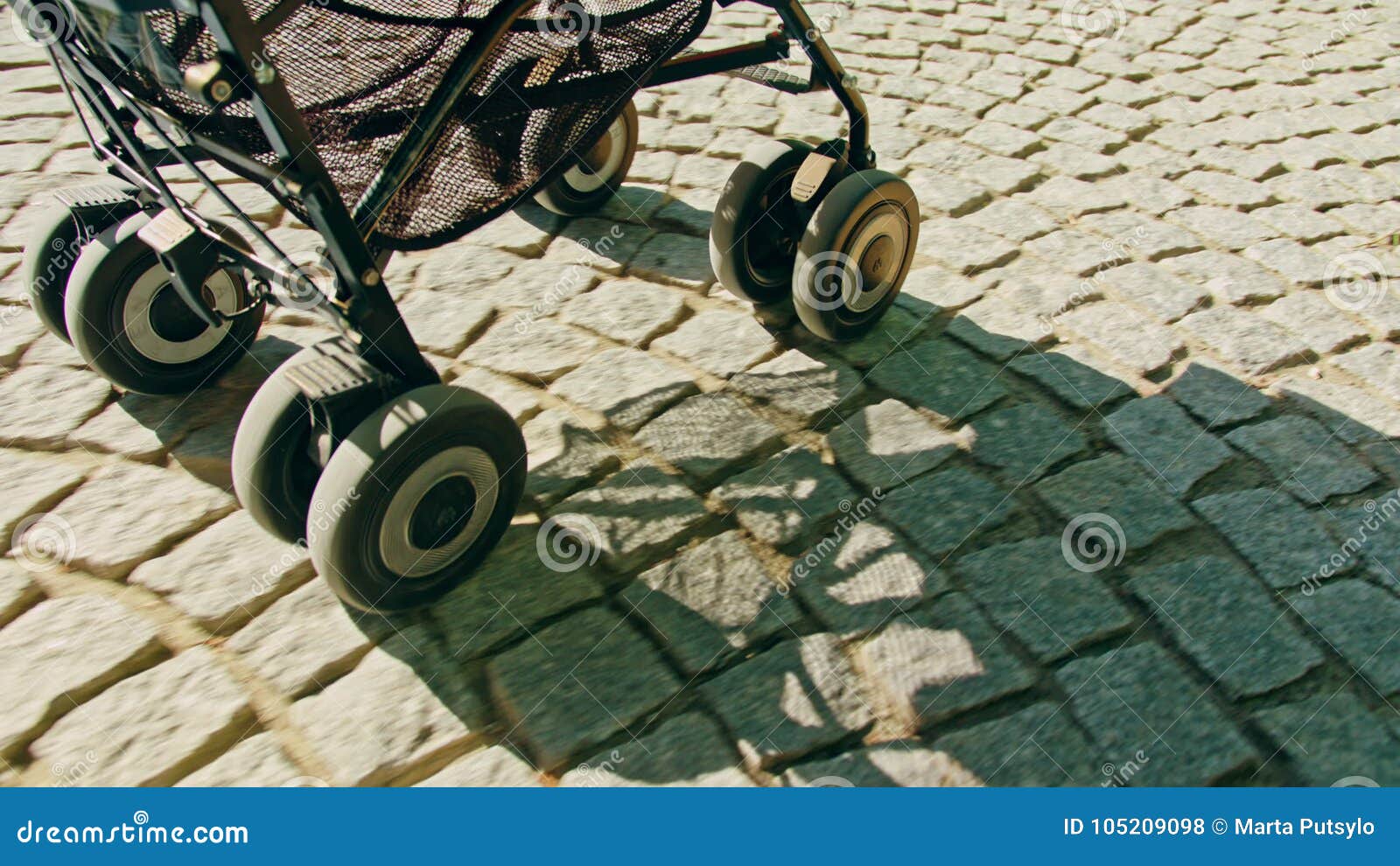 Wheels of a Stroller Rolling on Cobble Stone Road Stock Photo - Image ...