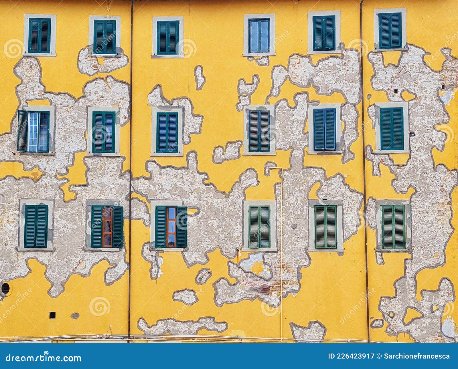 Whimsical Exterior Facade of a Yellow and Patchy Building Stock Image ...