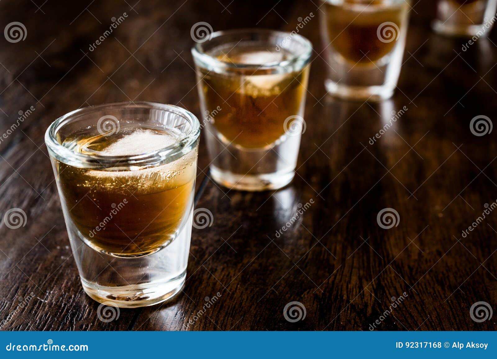 Whiskey Shots with Ice on Dark Wooden Surface. Stock Photo - Image of ...
