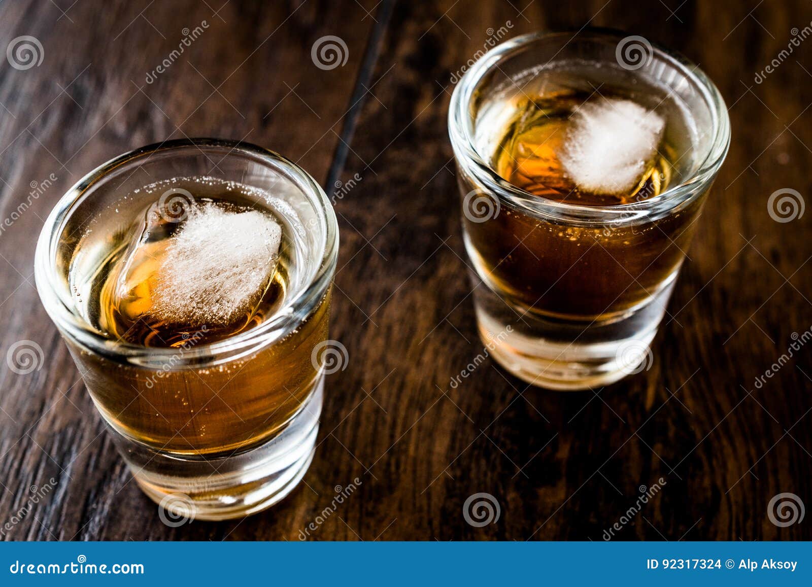 Whiskey Shots with Ice on Dark Wooden Surface. Stock Photo - Image of ...