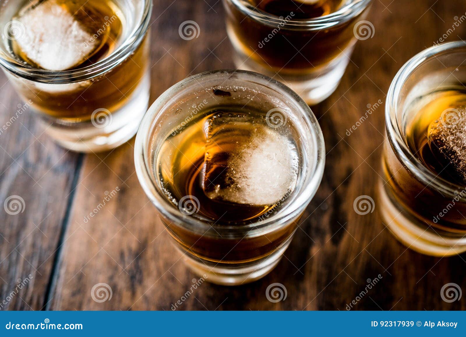 Whiskey Shots with Ice on Dark Wooden Surface. Stock Image - Image of ...