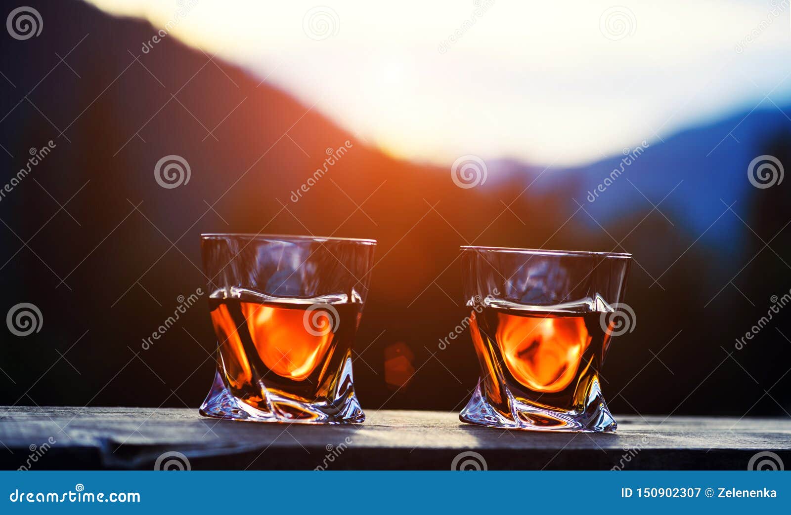 Whiskey at Sunset Dramatic Sky on Mountain Landscape Background Stock ...