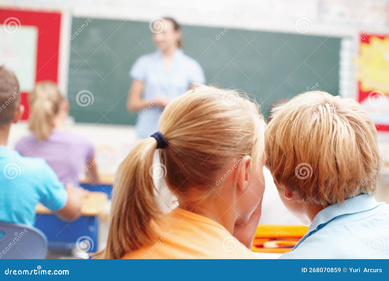 Whispering at the Back of Class. Rear View of Two Students Whispering ...