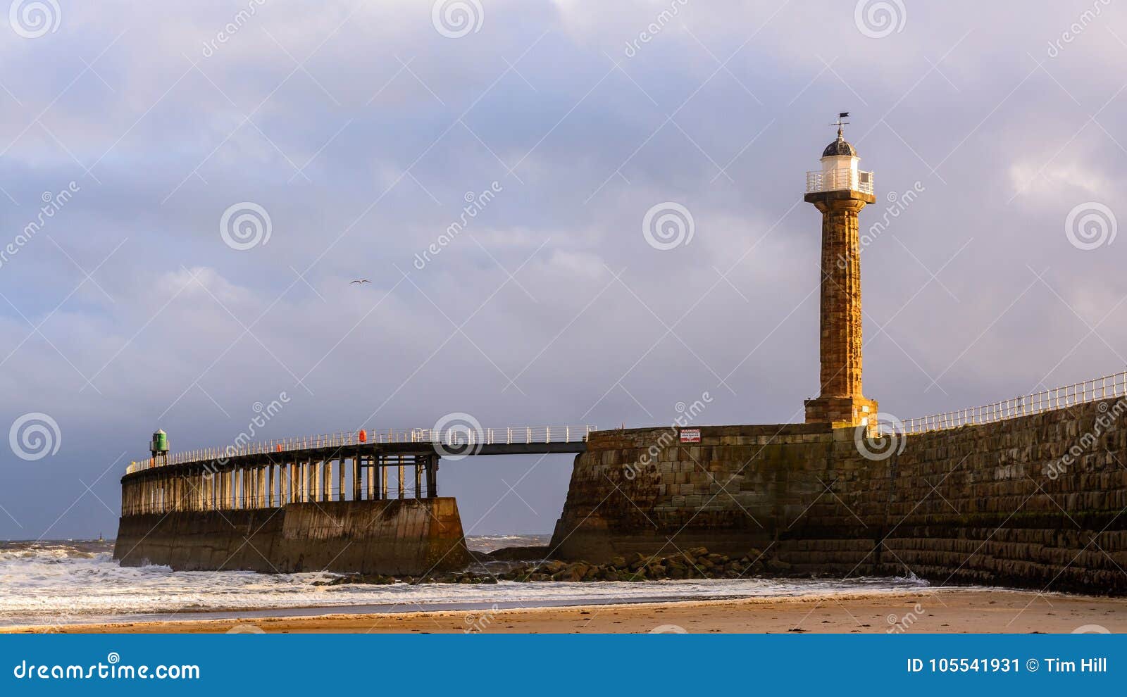 Whitby West Pier and Light from the Beach at Low Tide Stock Image ...