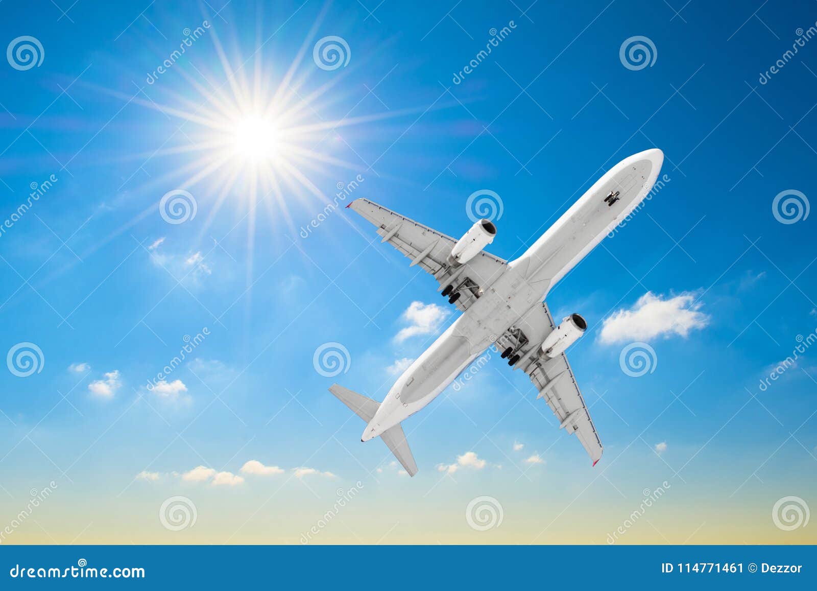 White Airplane Flies in a Blue Sky with a Bright Sun. Stock Image ...