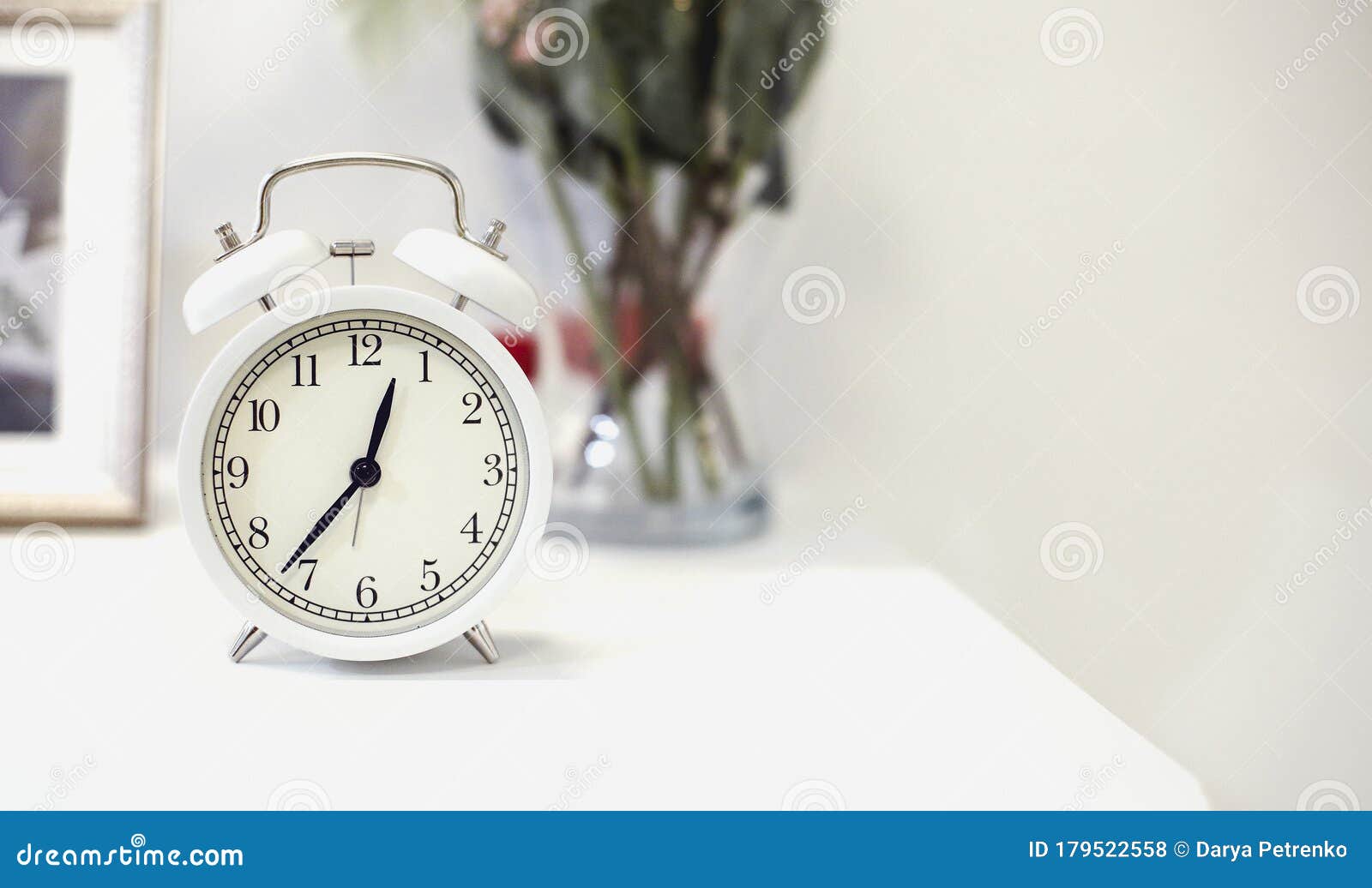 White Alarm Clock on Bedside Table. Close Up Stock Photo - Image of ...
