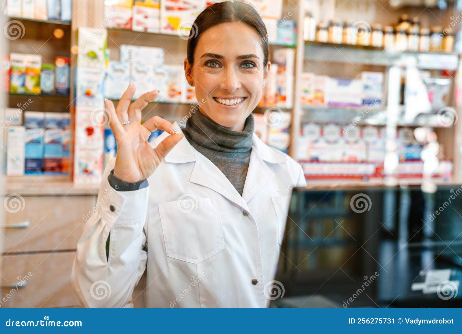 White Apothecary Gesturing while Working with Till at Pharmacy Stock ...