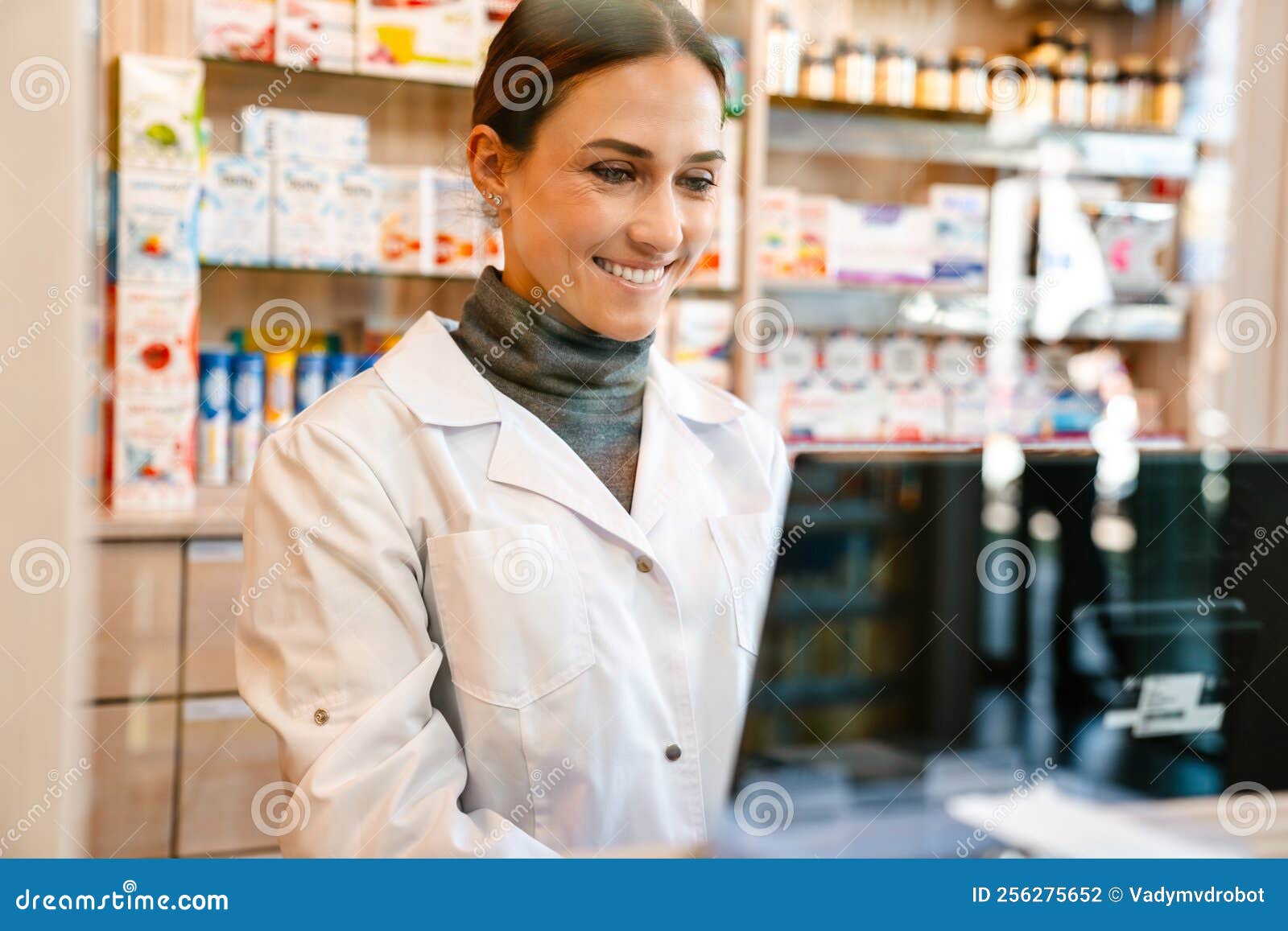 White Apothecary Smiling while Working with Till at Pharmacy Stock ...