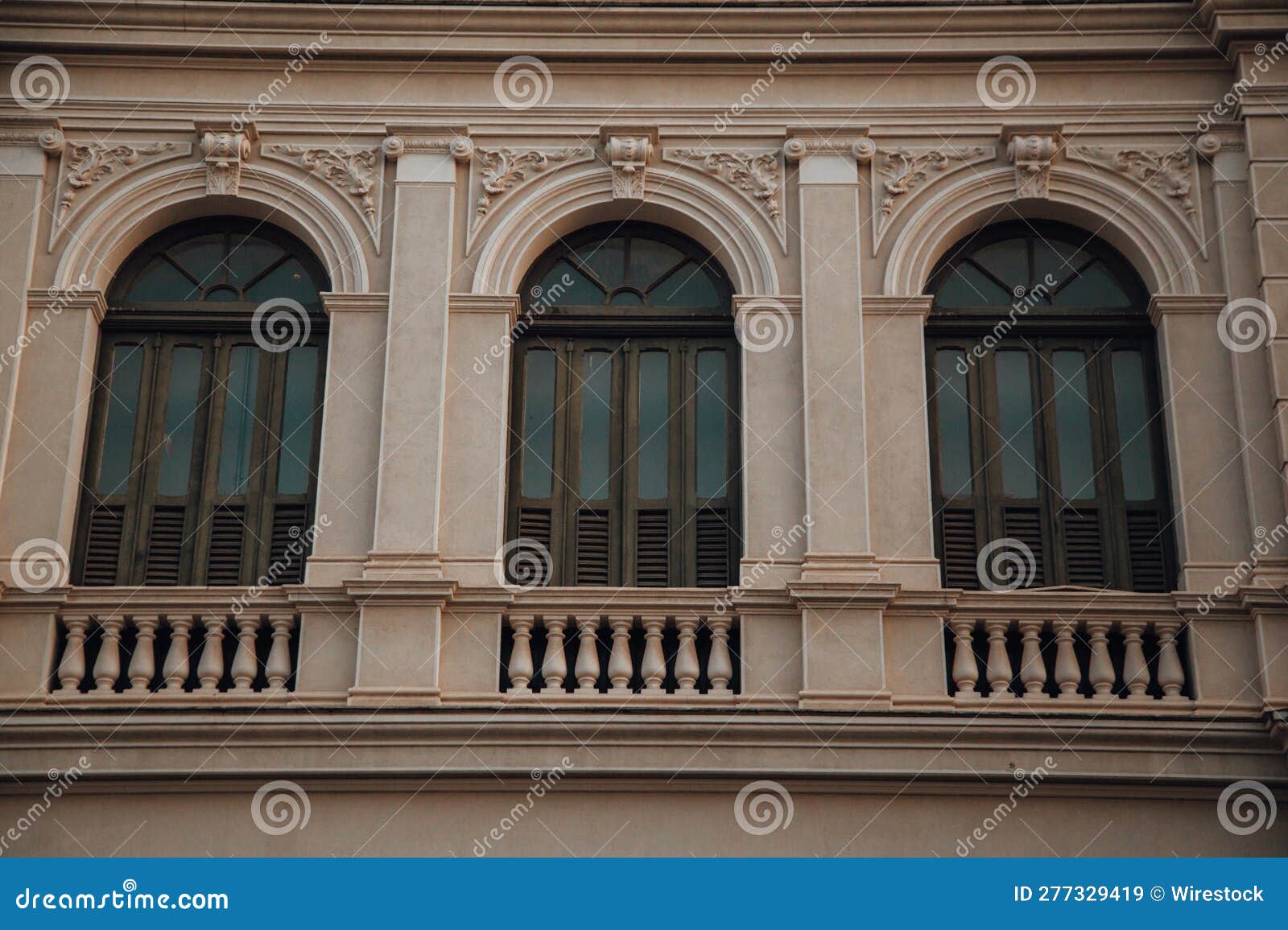 White Architectural Building Featuring Multiple Windows with Arch ...