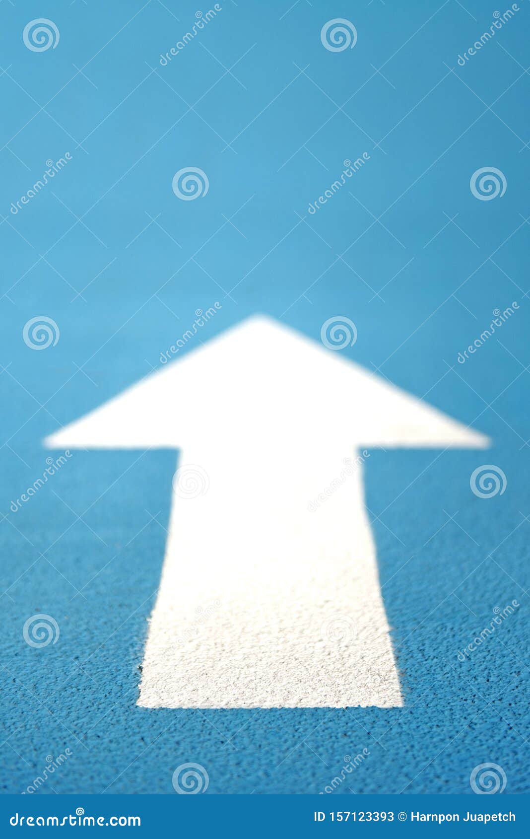 White Arrow on Blue Running Track with Soft Focus Stock Image - Image ...