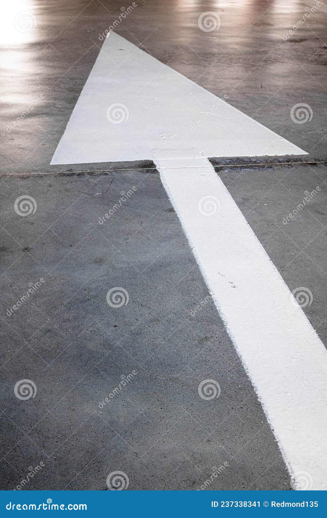 White Arrow Indicating the Direction of Entry or Exit on the Floor ...