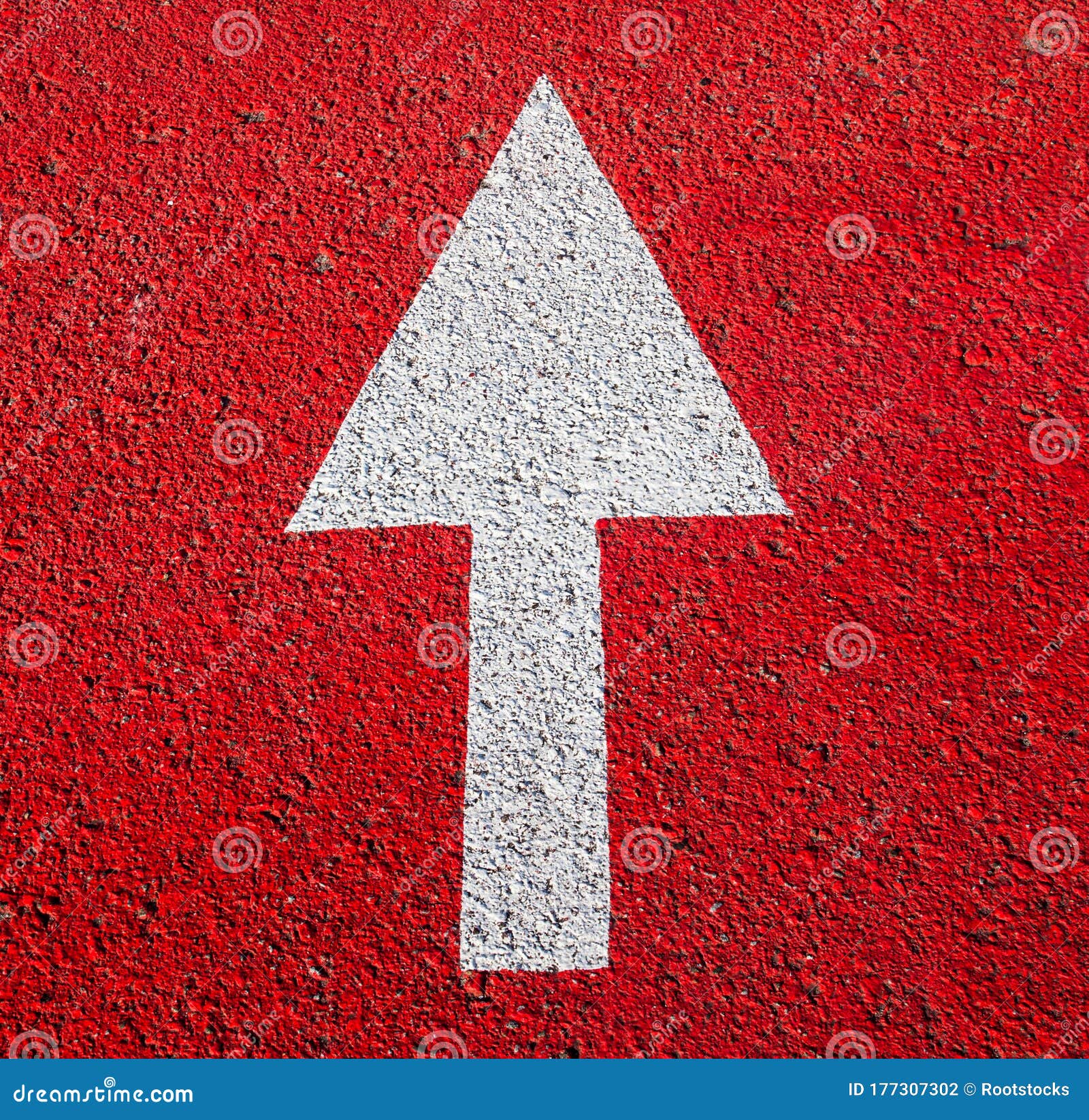 White Arrow on the Red Asphalt Surface Stock Photo - Image of ...