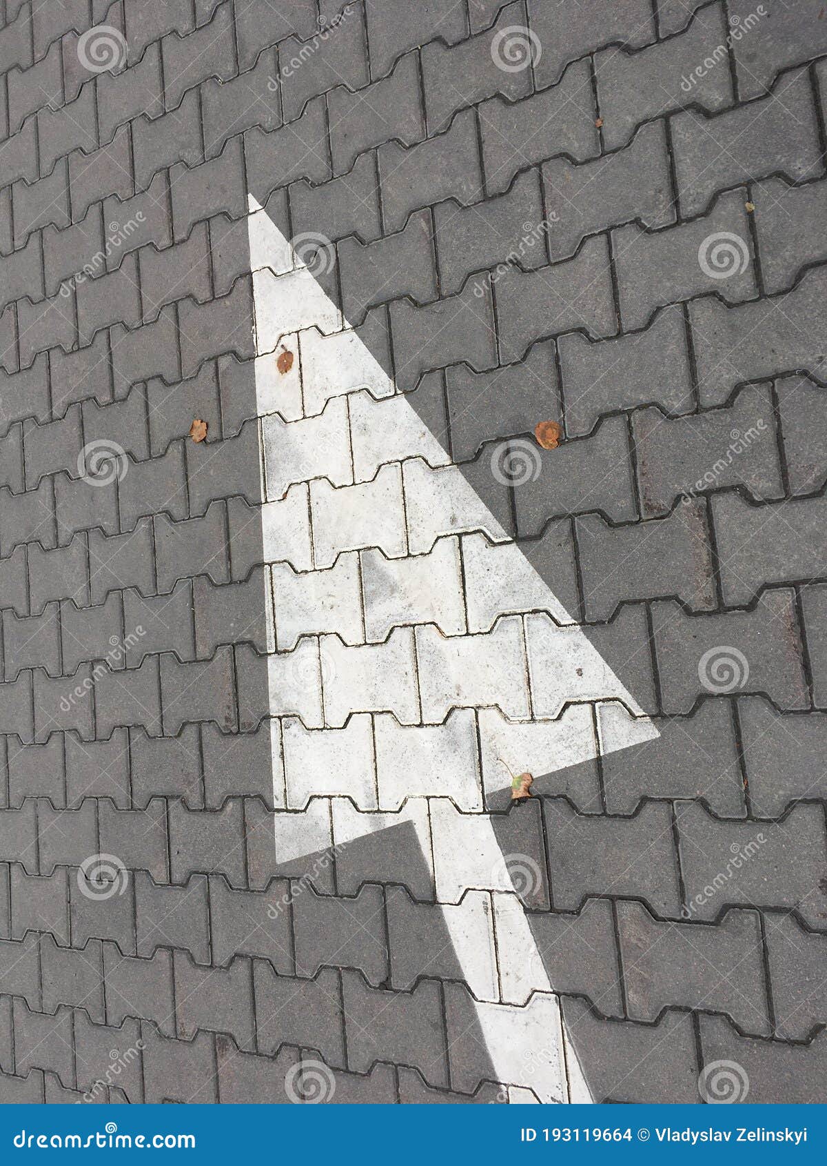 White arrow on road tile stock photo. Image of europe - 193119664