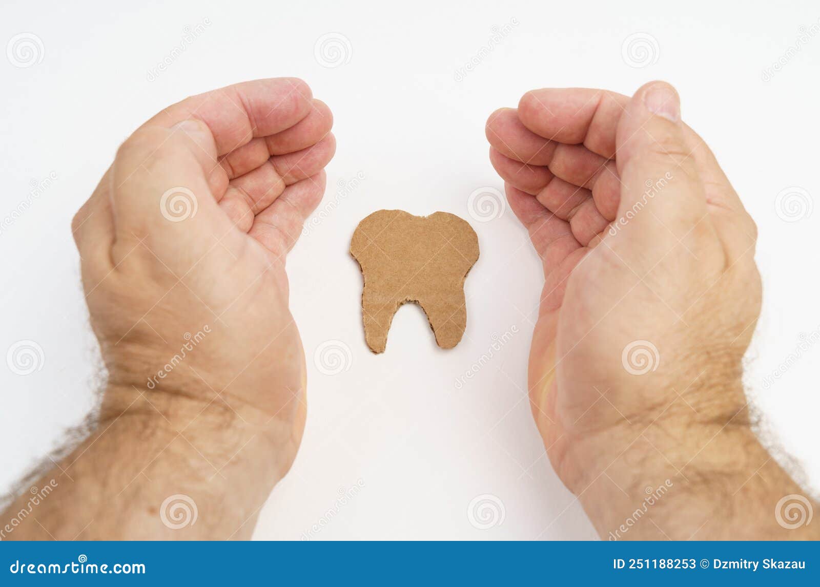 On a White Background, the Symbol of the Tooth Inside the Hands of a ...