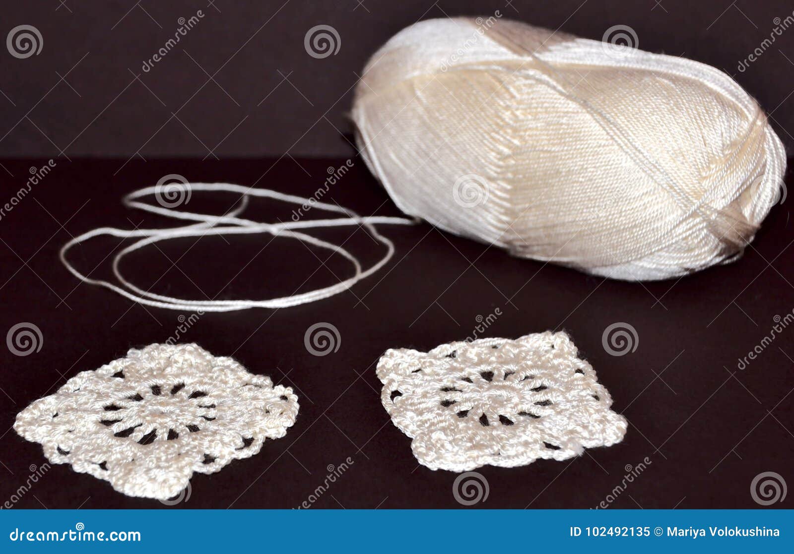 White Ball of Yarn and Knitting Patterns of Lace on the Brown Surface ...