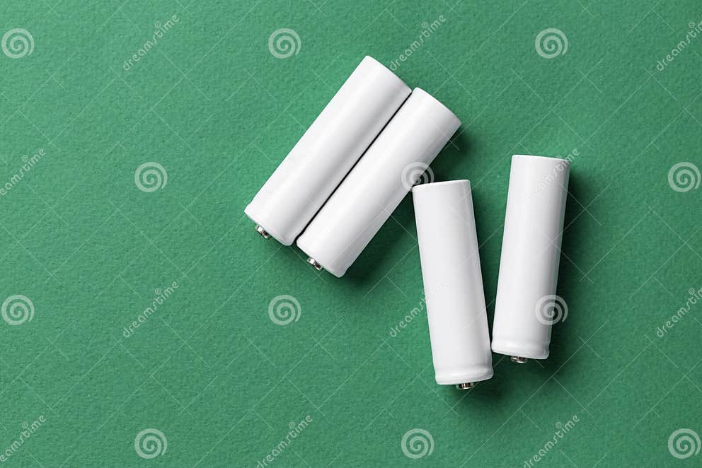 White Batteries on a Green Background Stock Photo - Image of close ...