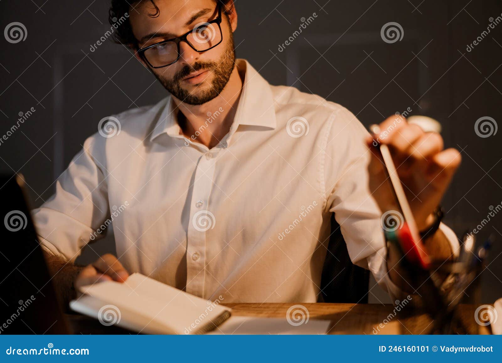 White Man Writing Down Notes in Planner while Working at Office Stock ...