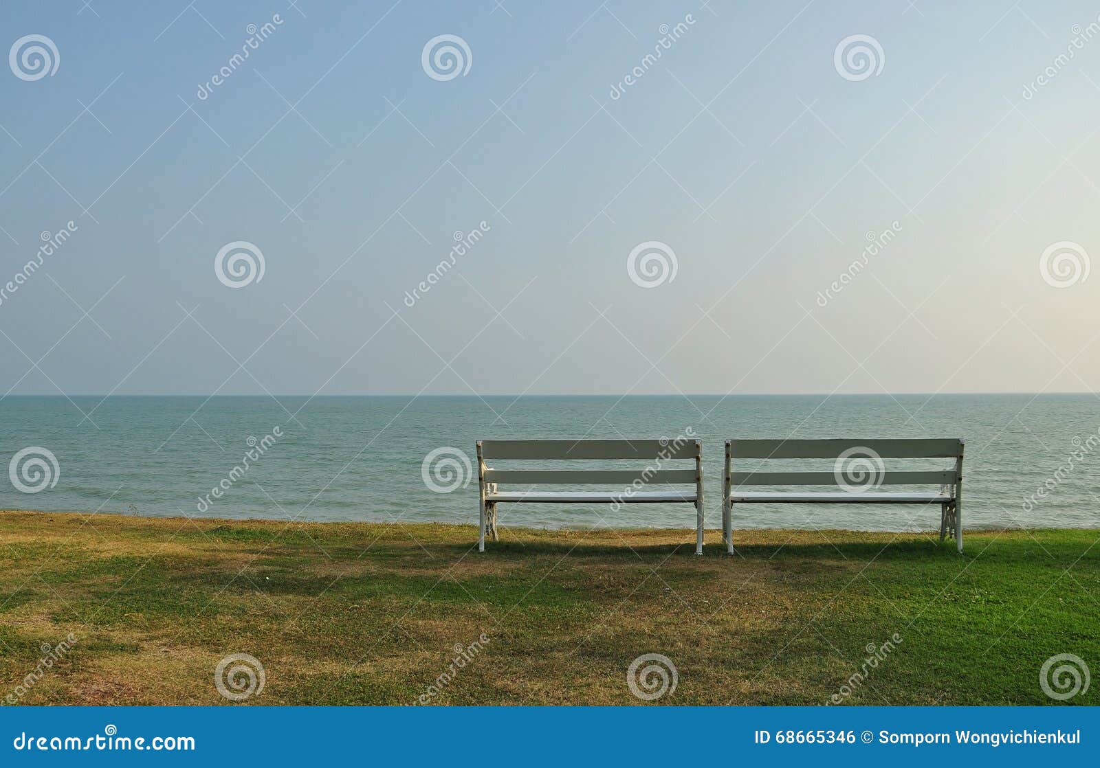 White Benches on the Beach in Front of the Sea Stock Photo - Image of ...