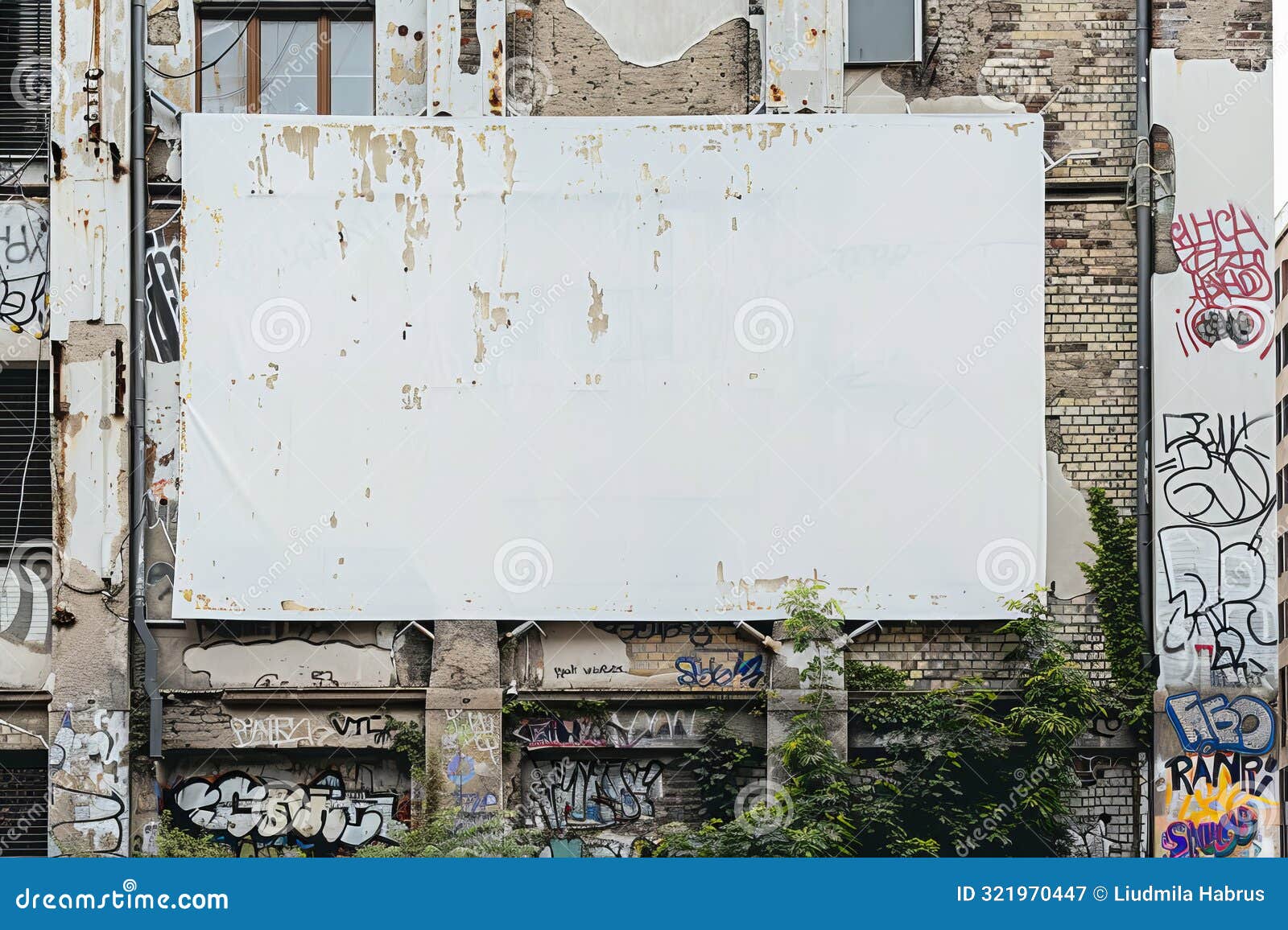 A White Billboard with Graffiti on the Side of a Building Stock Image ...