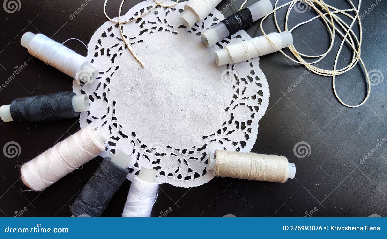 White and Black Spools of Thread with Decorative Napkin on a Black ...