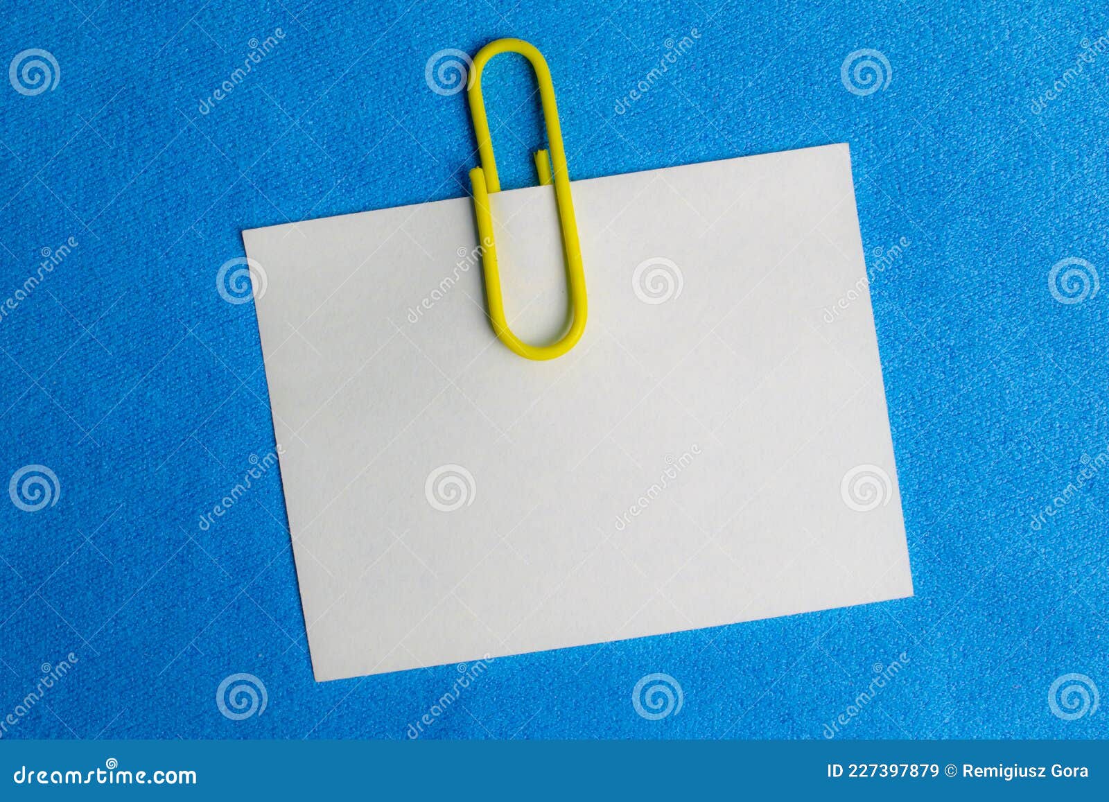 White Blank Note Pinned To a Blue Notice Board with a Paper Clip Stock ...
