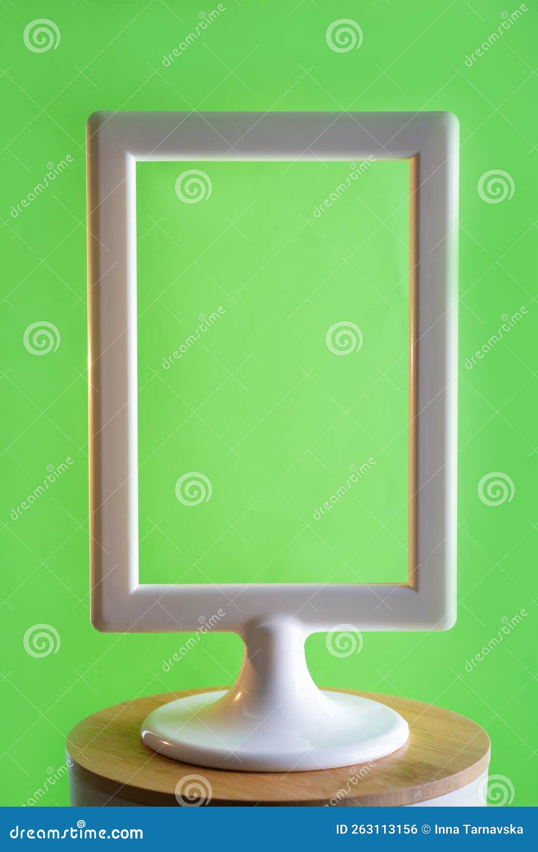 White Blank Photo Frame Stay on Stand on Green Background. Vertical ...