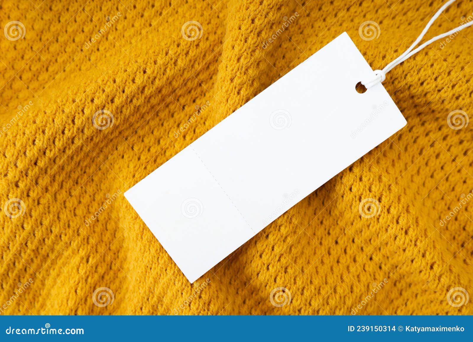 White Blank Rectangular Clothing Tag on Yellow Knitted Fabric ...