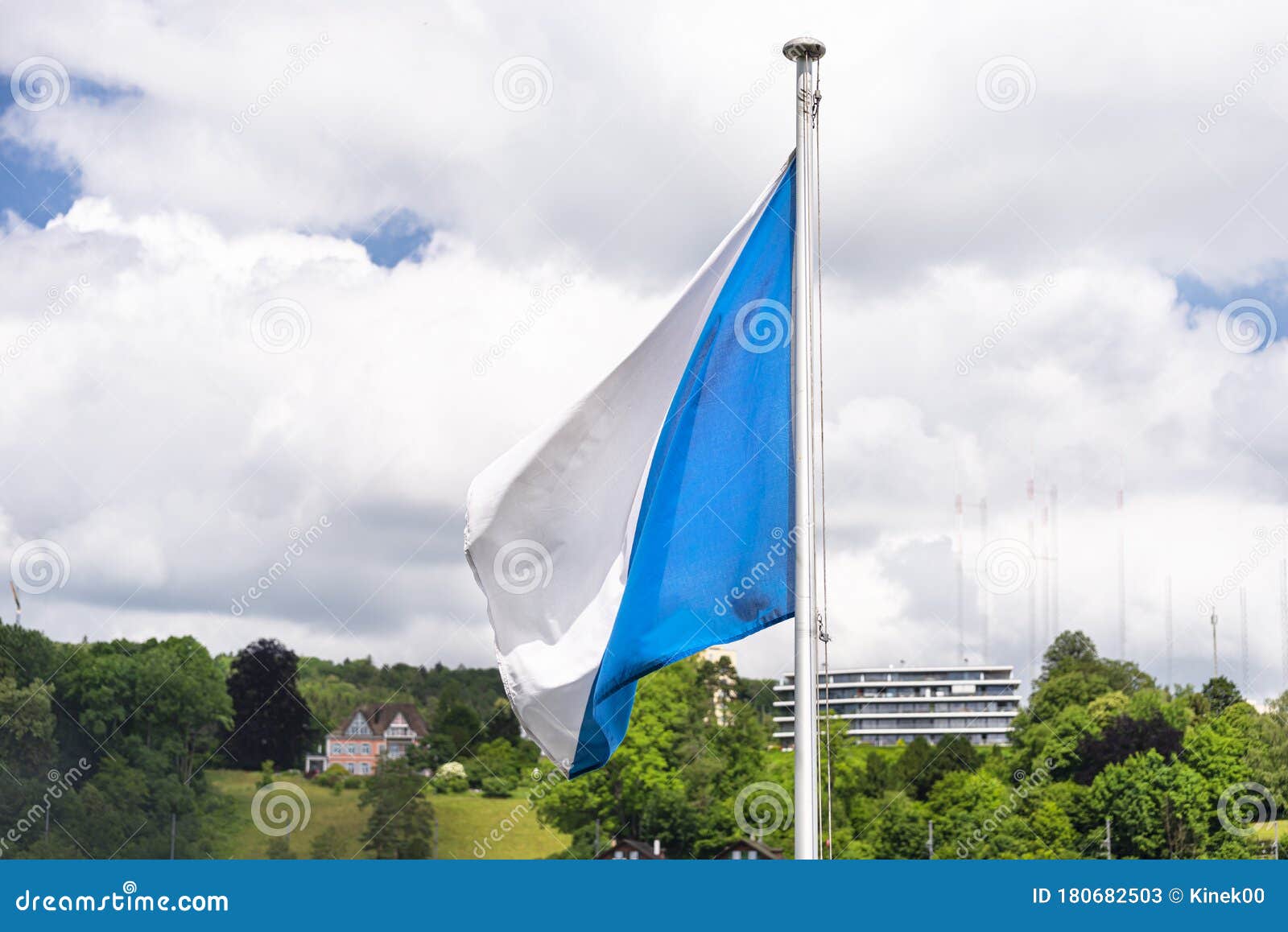 A White and Blue Flag Hanging on the Mast Slightly Fluttering To the ...
