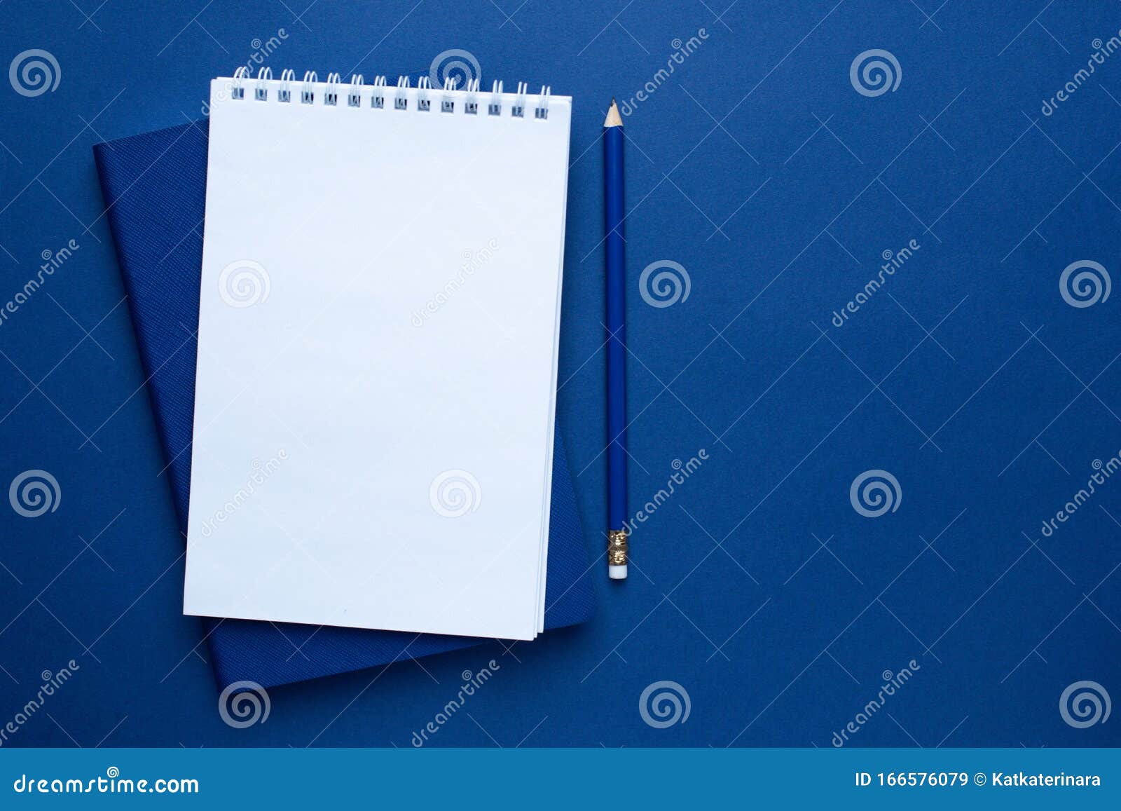 White, Blue Office Notebook and Pencil on a Classic Blue Background ...