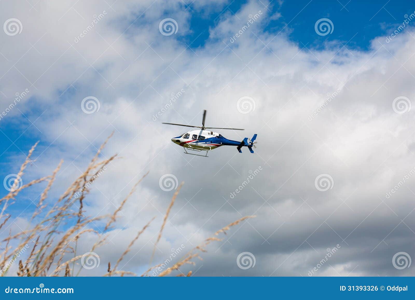 White Blue Red Painted Helicopter in Flight Stock Photo - Image of ...