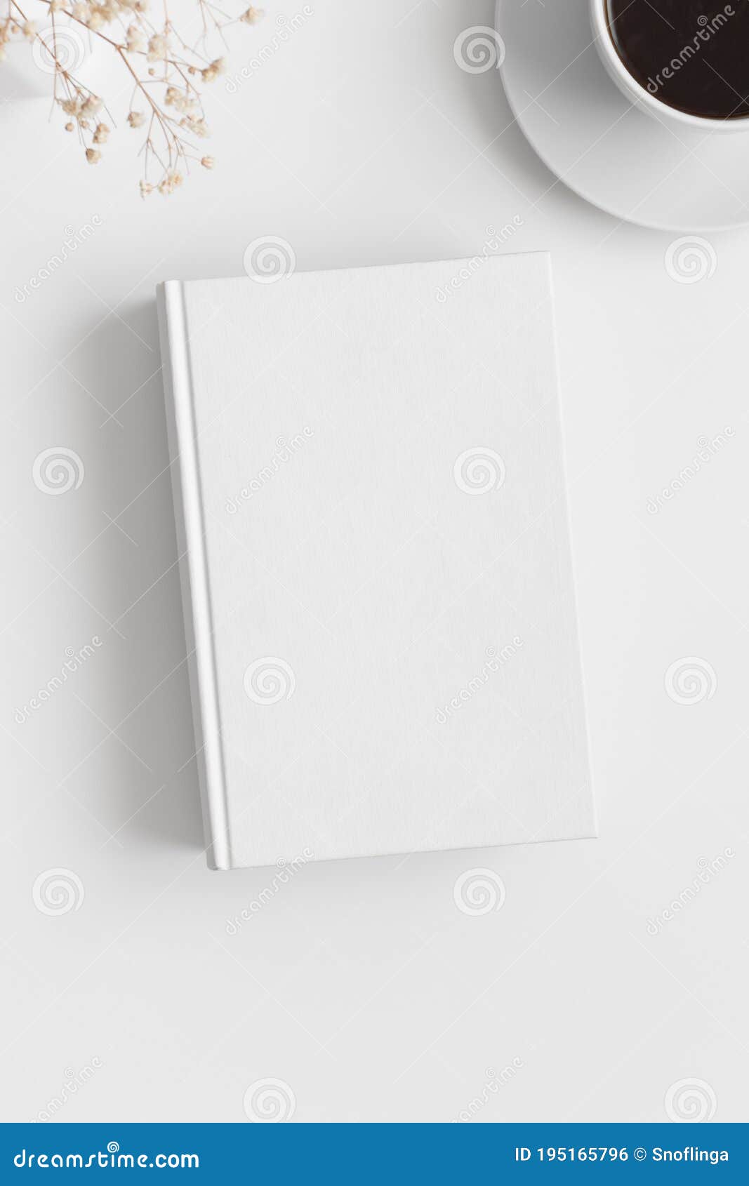 White Book Mockup with a Cup of Coffee and Gypsophila on a White Table ...