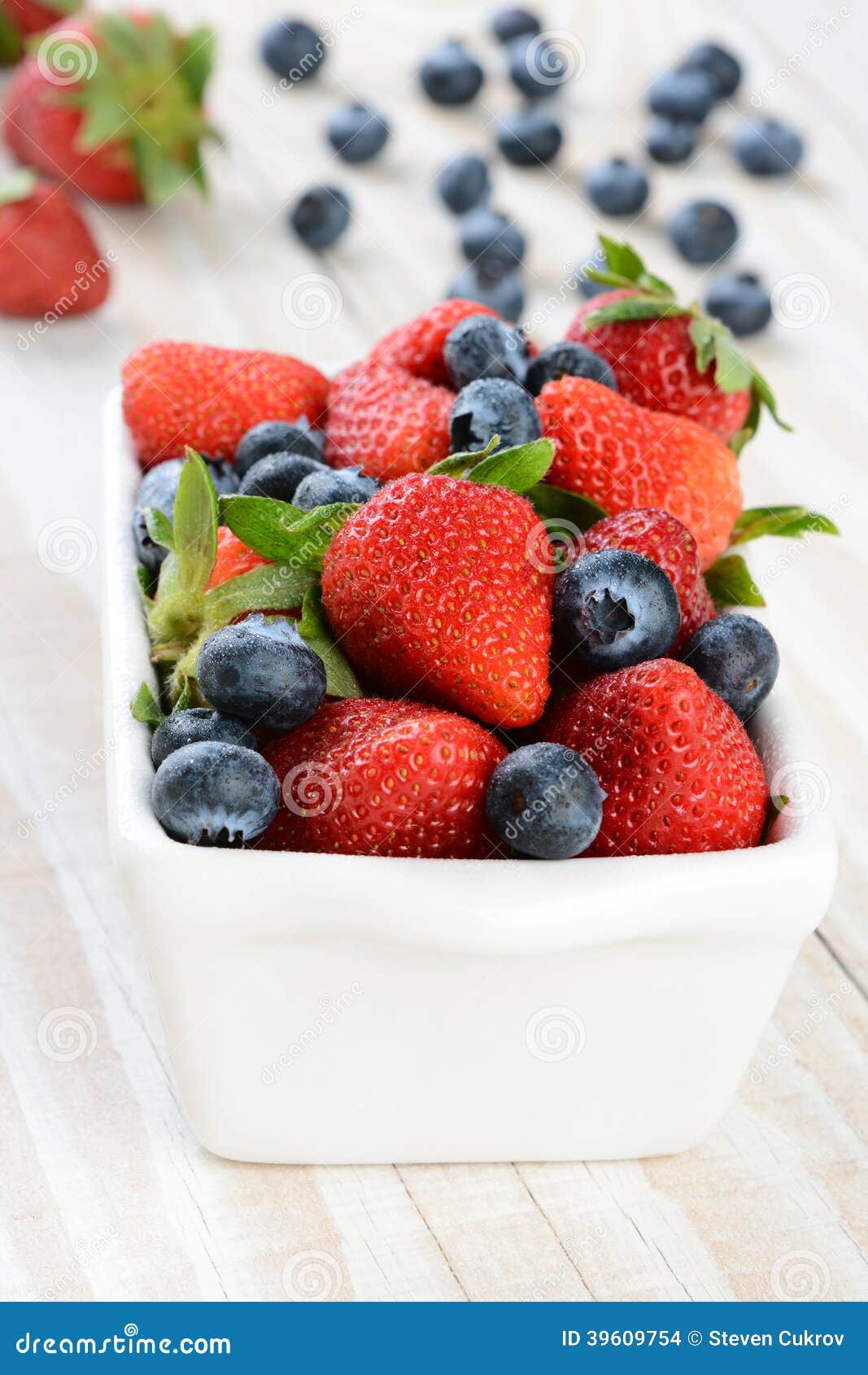 White Bowl of Strawberries and Blueberries on Rustic Table Stock Photo ...