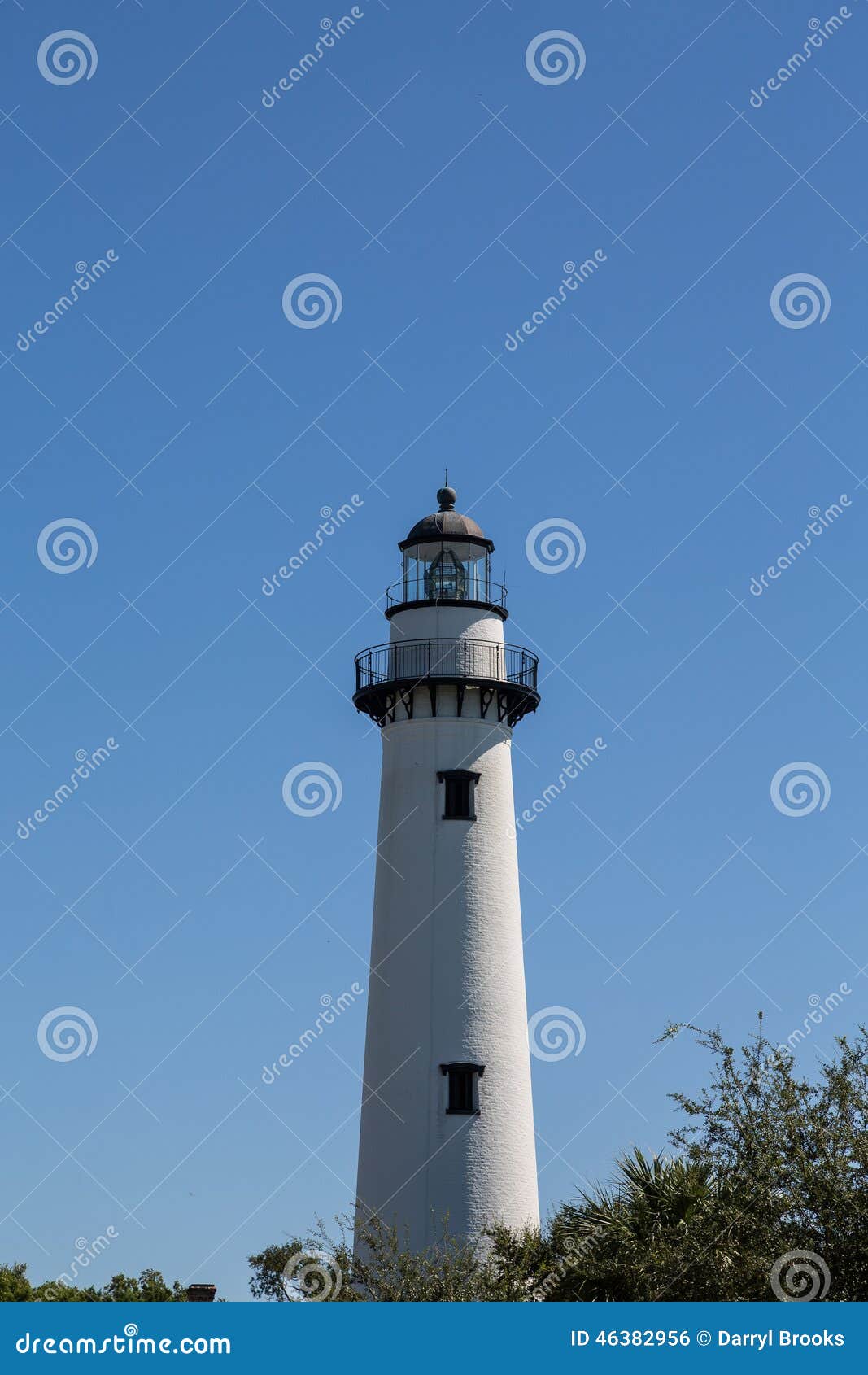 White Brick Lighthouse with Black Iron Hardware Under Blue Skies Stock ...