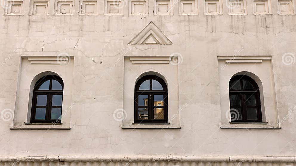 A White Building with Arched Windows and a Triangular Roof Stock Photo ...