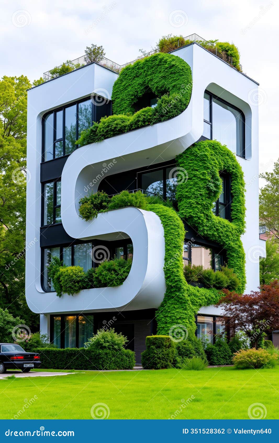 A White Building with Plants Growing on the Side of it Stock Photo ...